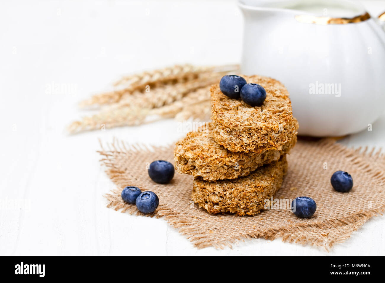 Wholegrain wheat bisks with milk and blueberry Stock Photo - Alamy