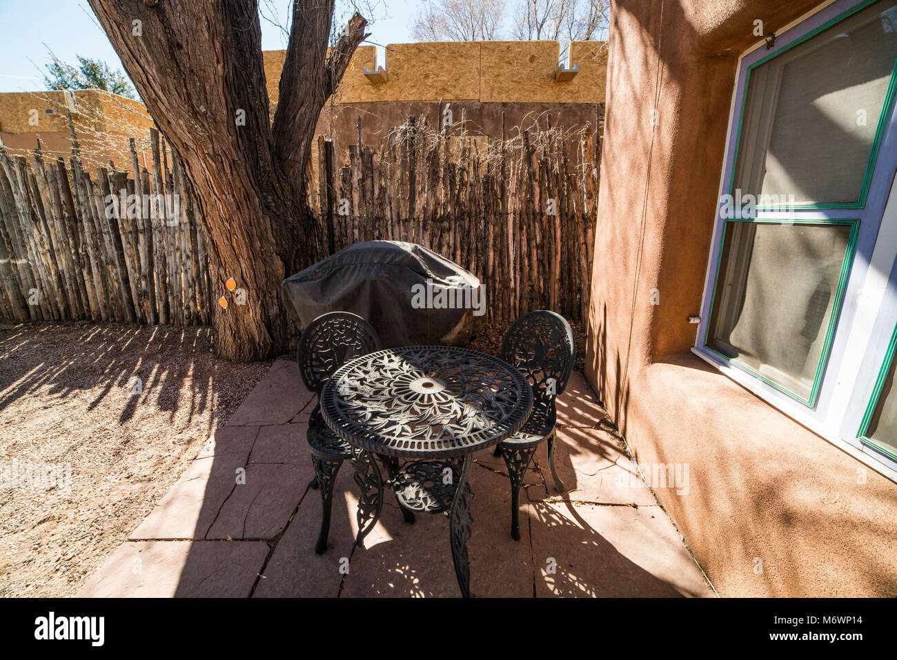 A patio in Santa Fe, New Mexico at a red adobe home in the heart of ...