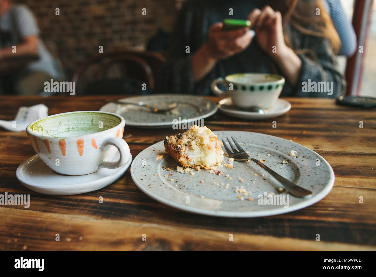 A dirty plate and an empty cup of coffee. The half-eaten cupcake on a ...