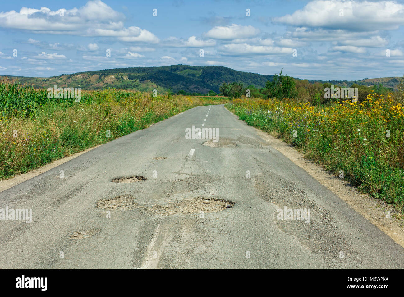 big hole cracked in the asphalt, road view Stock Photo - Alamy