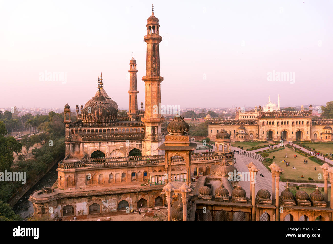 domed roof and towers of Asfi mosque shot at sunset from the rooftop of ...