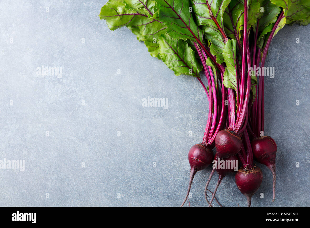 Beet, beetroot bunch on grey stone background. Copy space. Top view ...