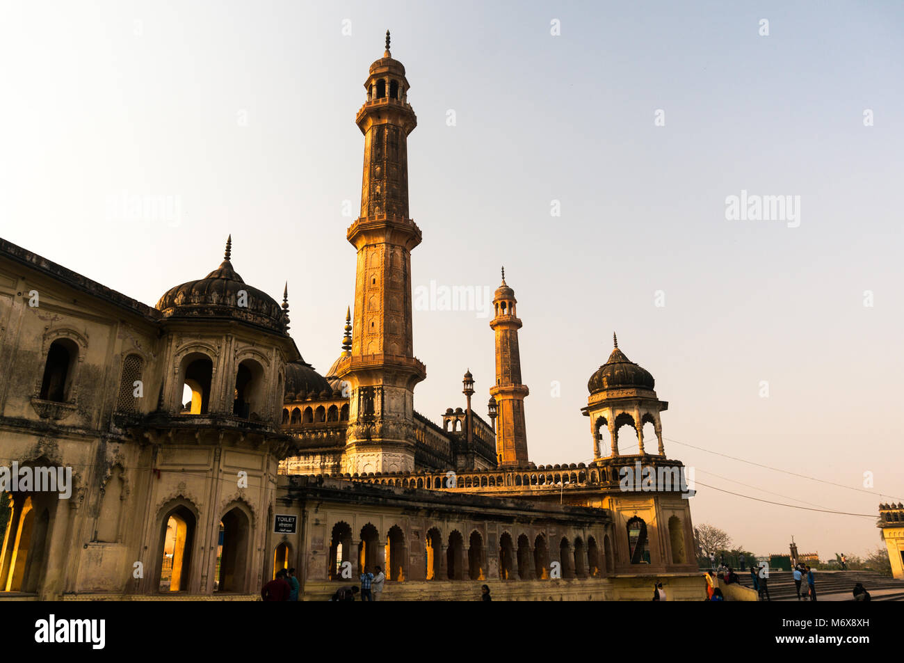 The entrance and gardens of the bara imambara. The spires and dome of ...