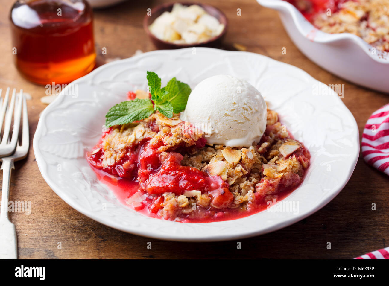 Crumble with berries and fruits with vanilla ice cream Stock Photo - Alamy