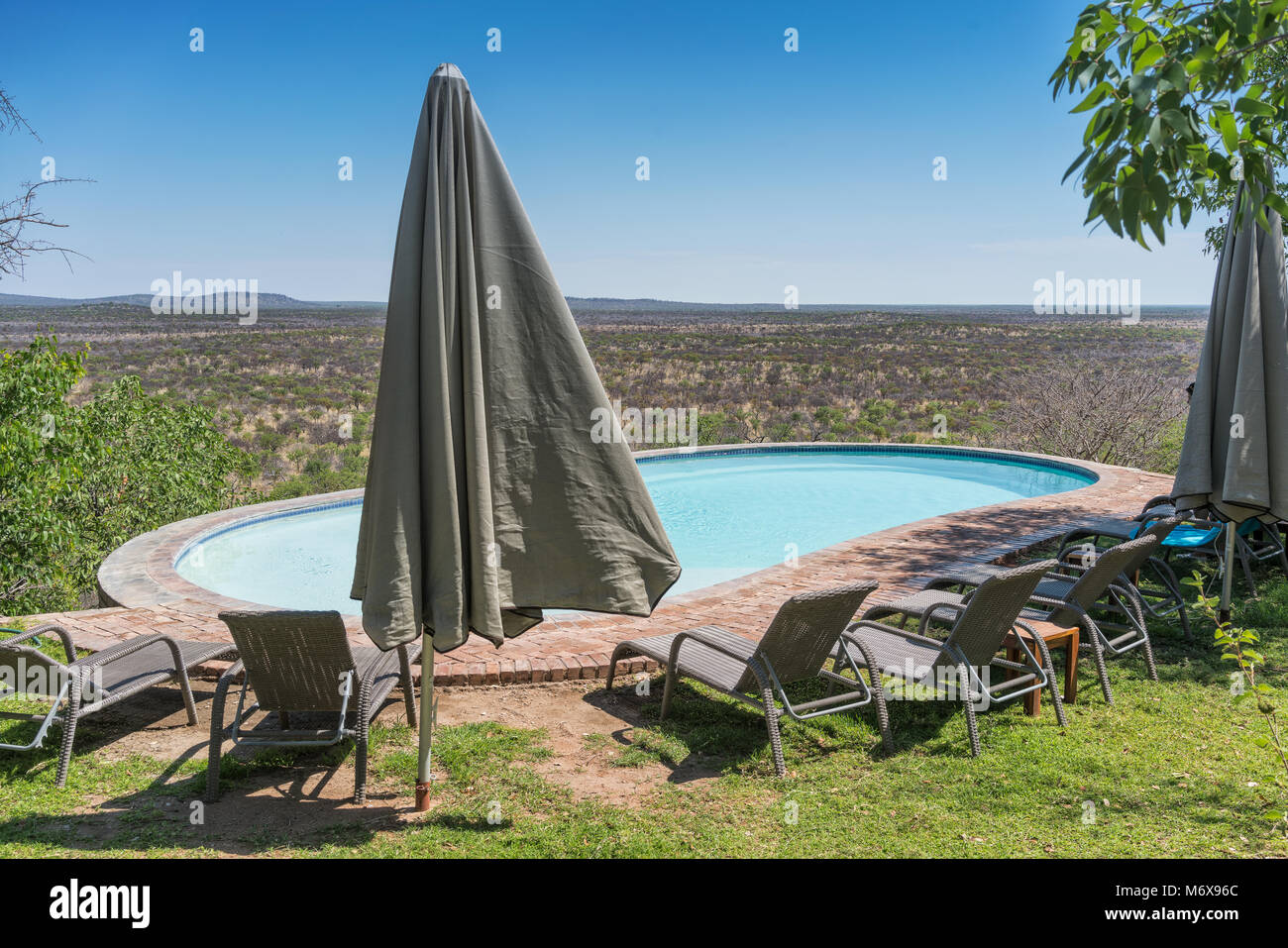 Pool with chairs overlooking the Namibian African savannah Stock Photo ...