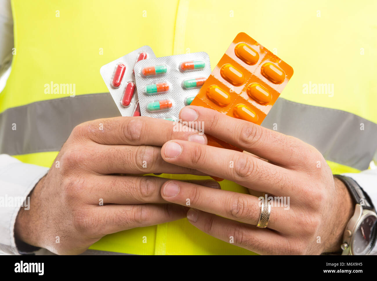 Constructor or builder hands holding pills capsules blisters as ...