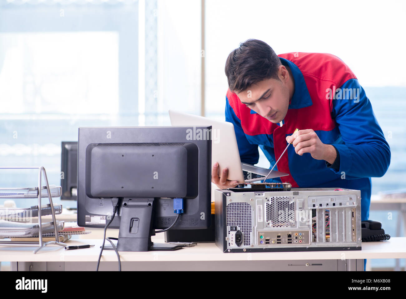 Computer repairman specialist repairing computer desktop Stock Photo ...