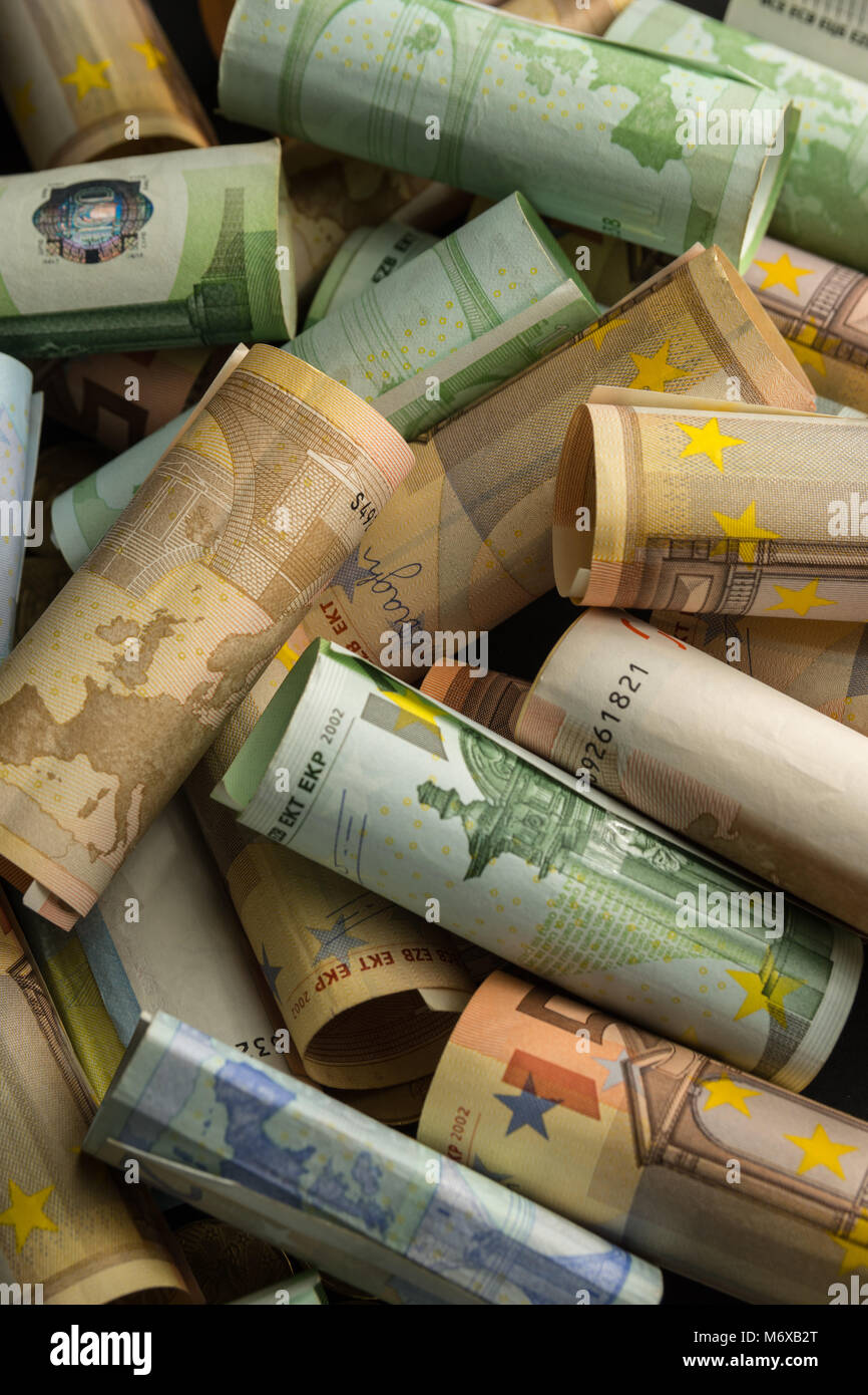 Money euro coins and banknotes in rolls Stock Photo - Alamy