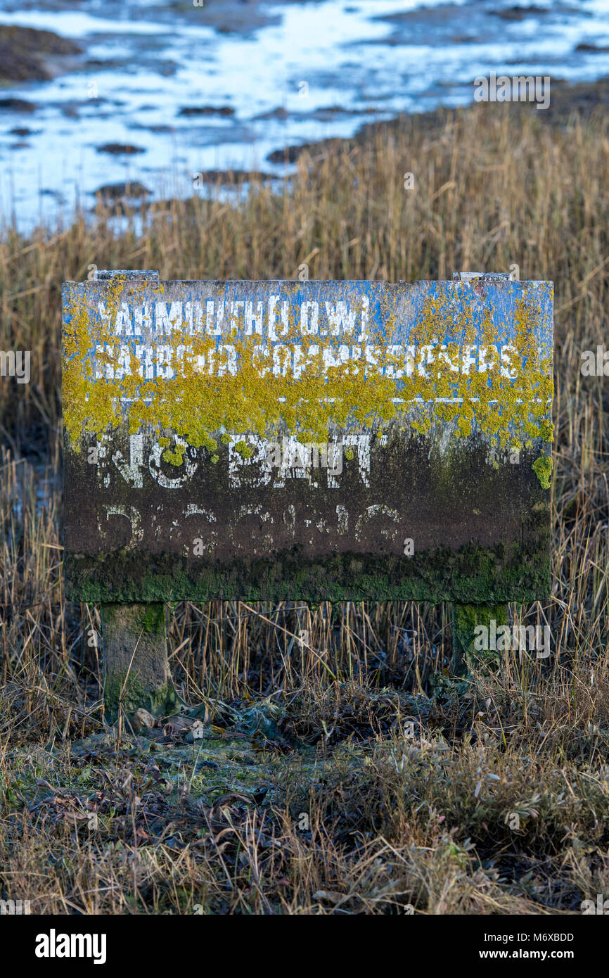 An old water damaged rotten sign in yarmouth harbour on the Isle of ...