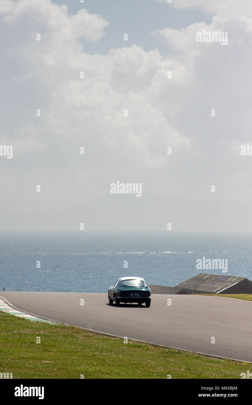 Classic sports car speeding around the Anglesey motor racing circuit ...