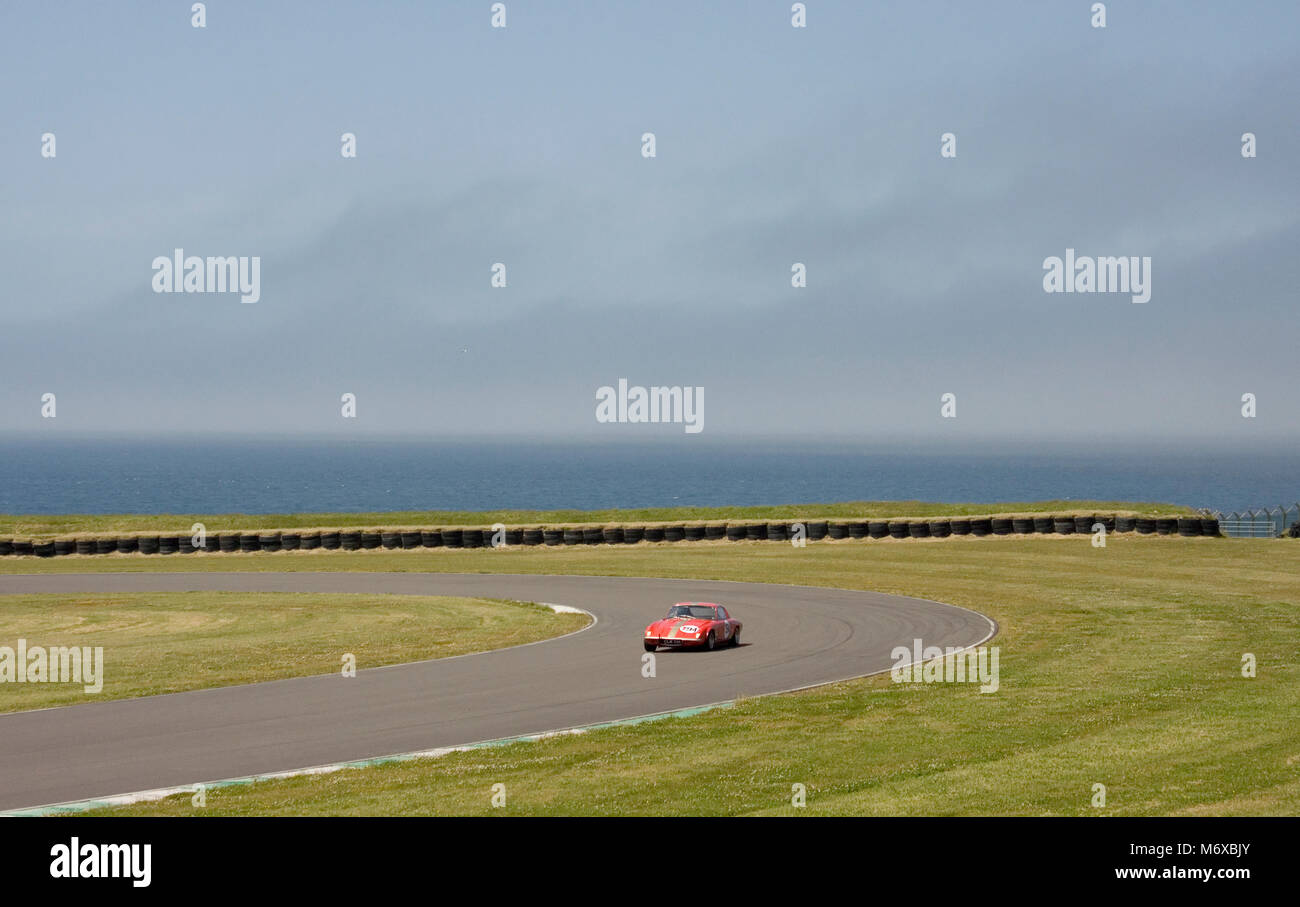 Red Lotus Elan speeding around the Anglesey motor racing circuit, Ty ...