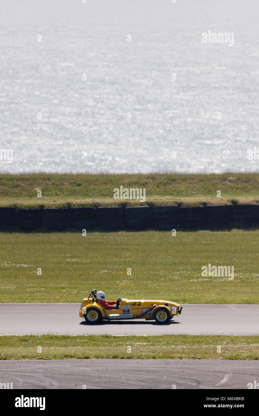 Classic sports car speeding around the Anglesey motor racing circuit ...
