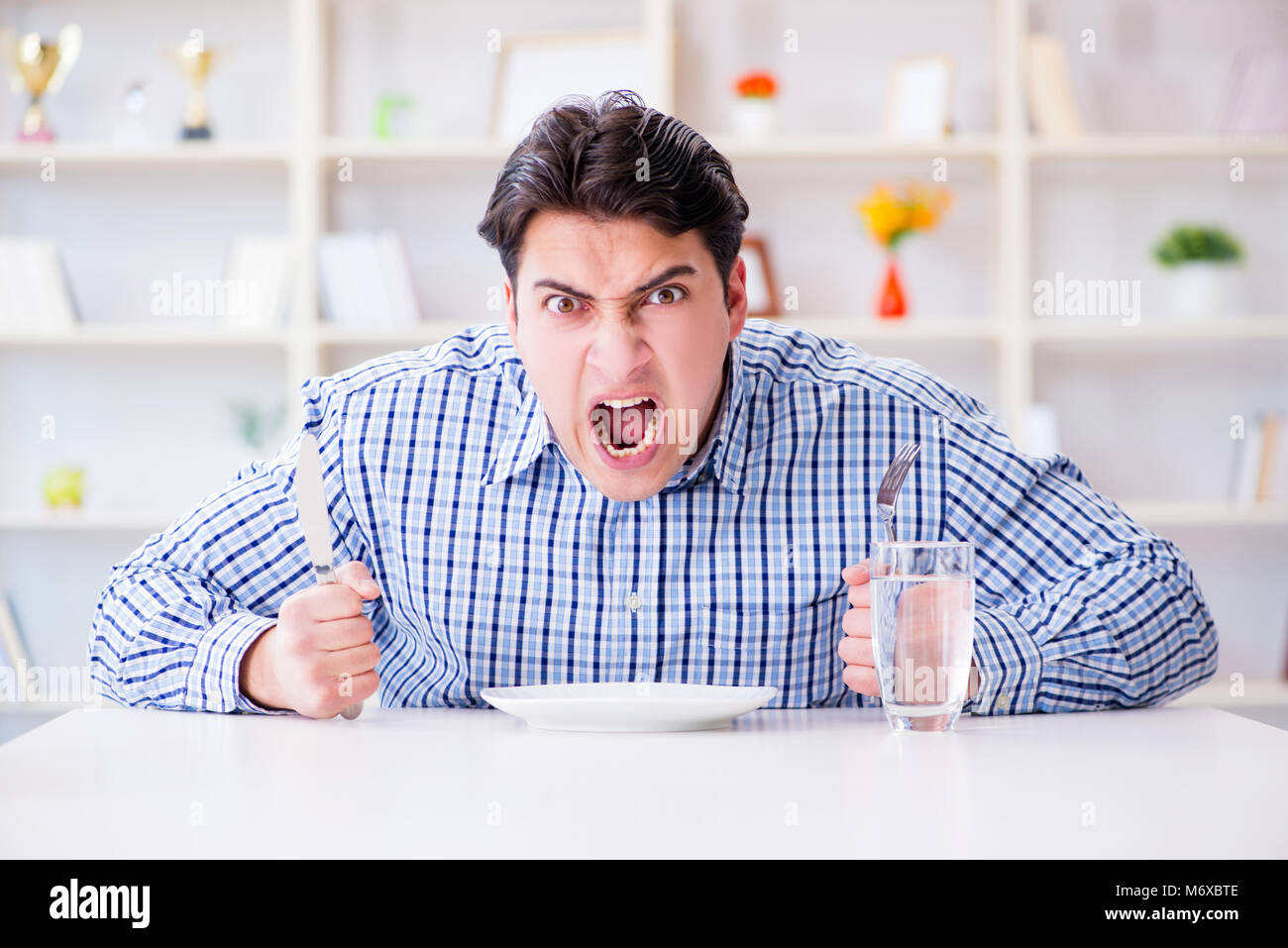 Angry man waiting food in hi-res stock photography and images - Alamy