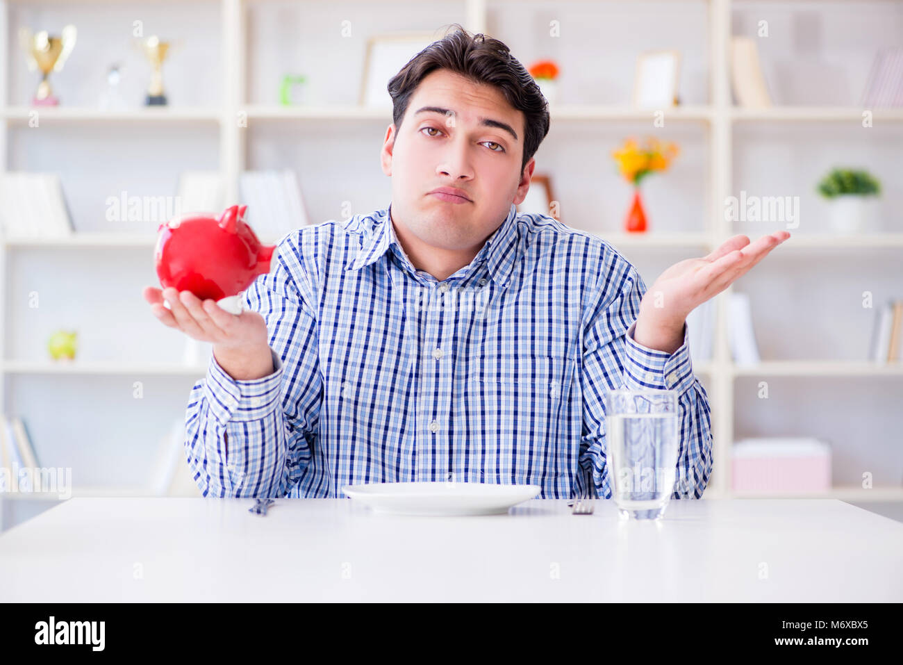 Man running out of money in restaurant and using savings from piggy ...