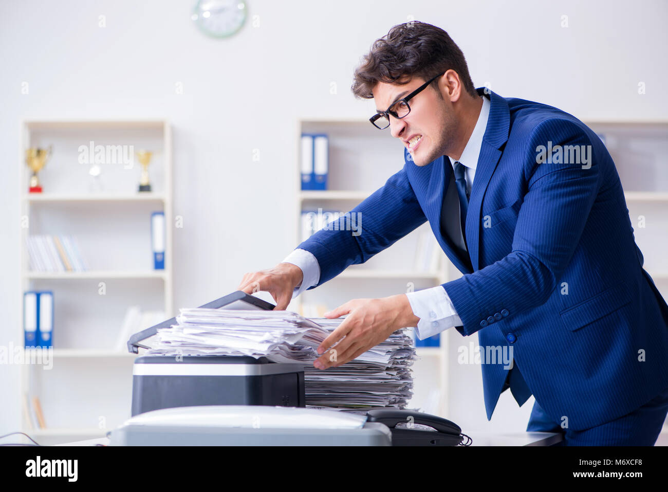 Businessman making copies in copying machine Stock Photo - Alamy