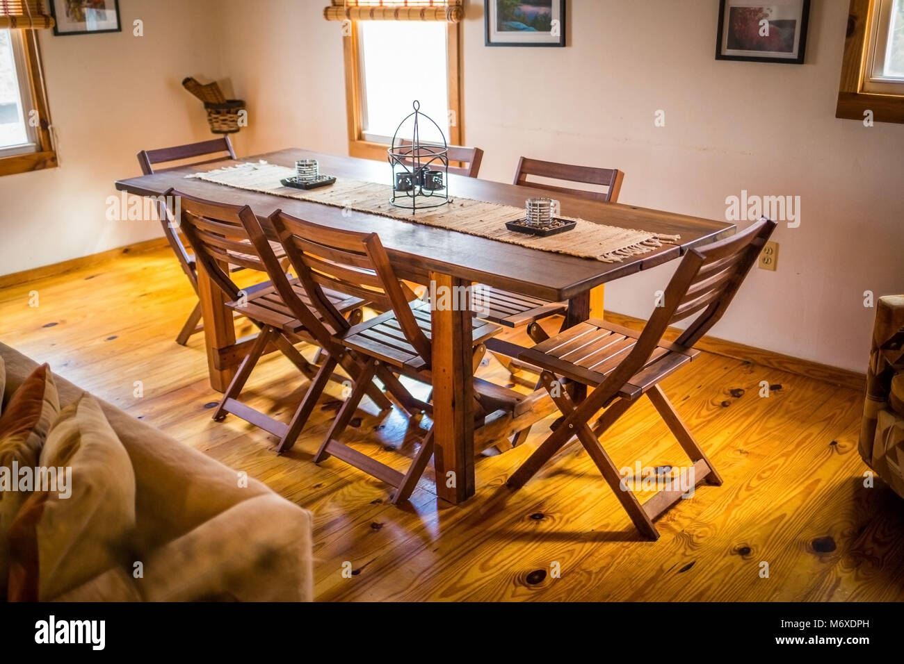Empty wooden dining table at home with chairs Stock Photo - Alamy