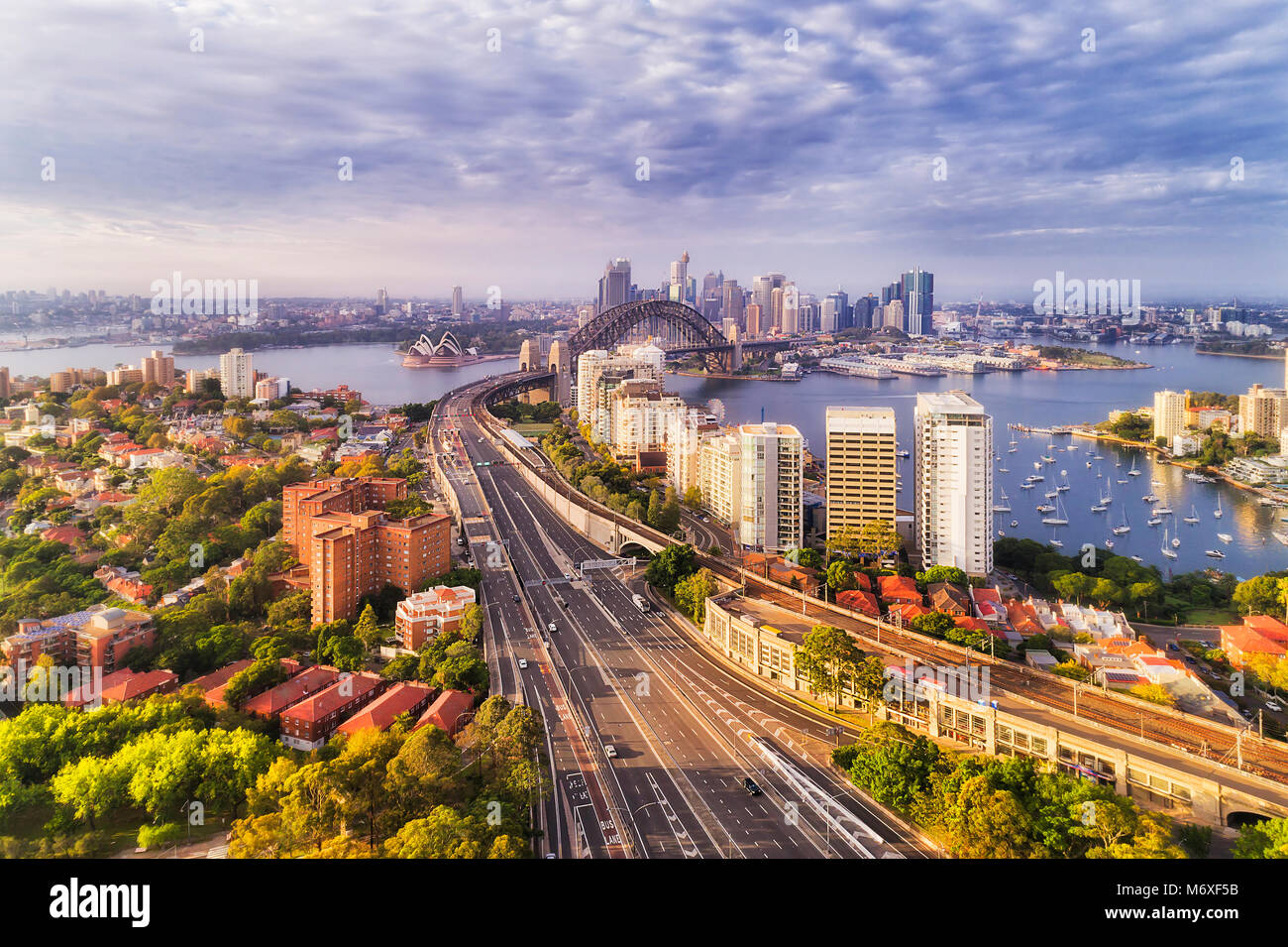 Soft morning light over Sydney city landmarks on both sides of harbour ...