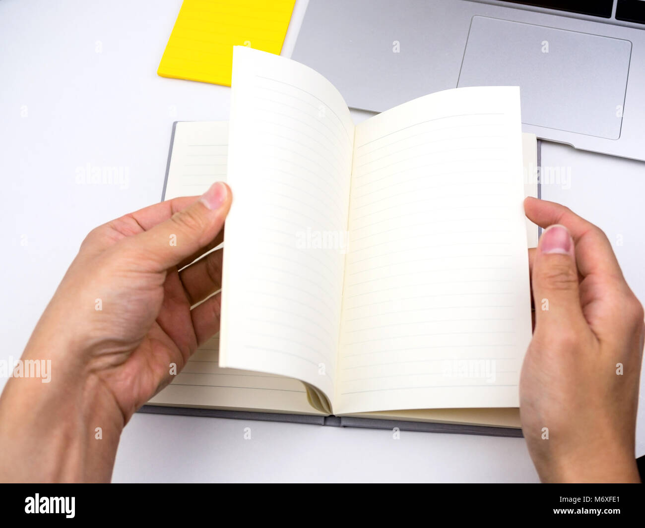 Flip and open notebook on desk Stock Photo - Alamy