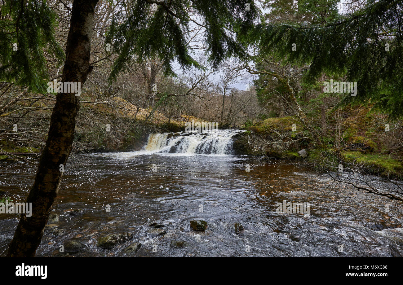 A small Waterfall with peat stained water tumbling over it into the ...