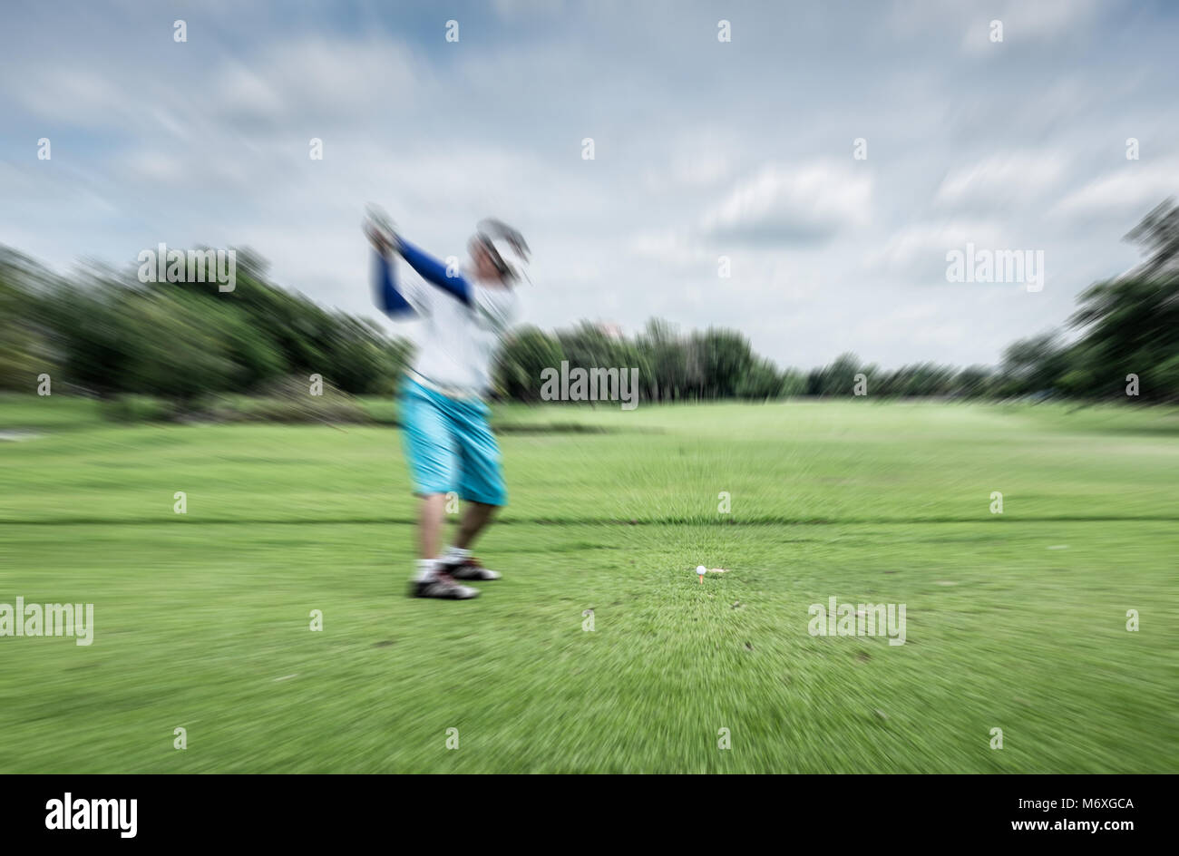 Motion blur golfer swinging driver club on teeing ground Stock Photo ...