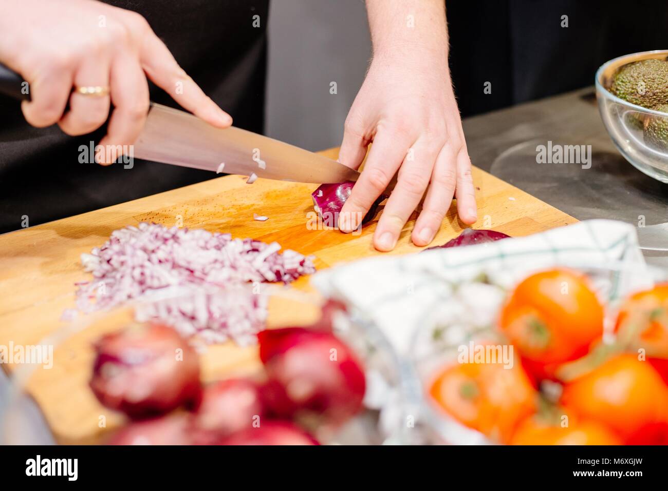 Woman cook cutting red onion on the wooden cutting board Stock Photo ...