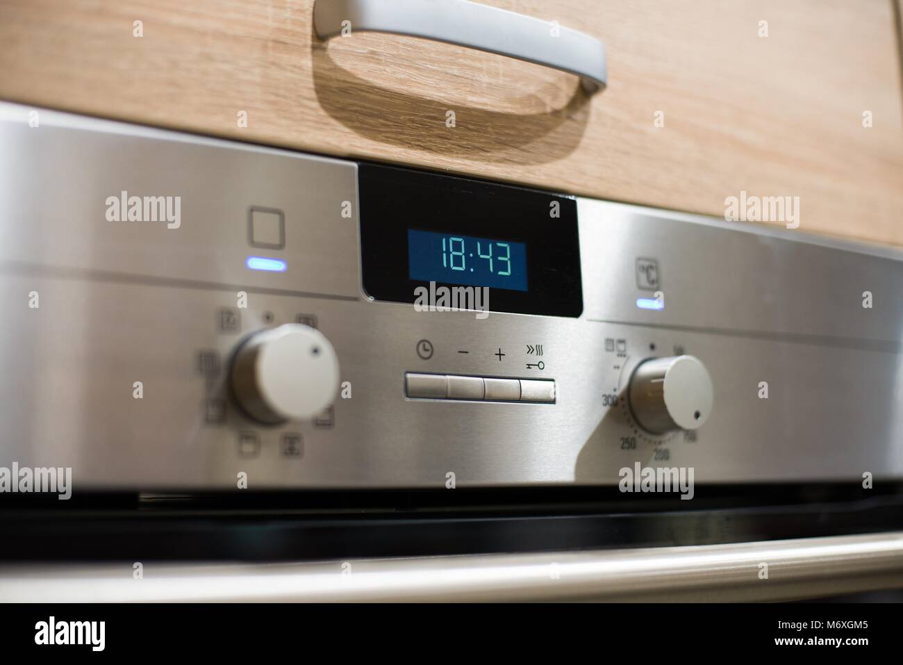 Metal electric kitchen oven control panel in the kitchen Stock Photo ...