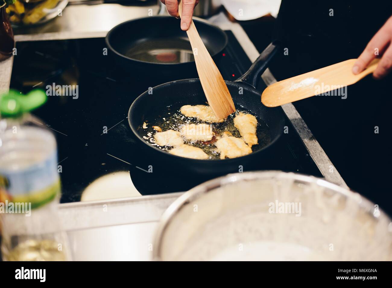 Woman frying breaded fish in hot oil on frying pan Stock Photo - Alamy