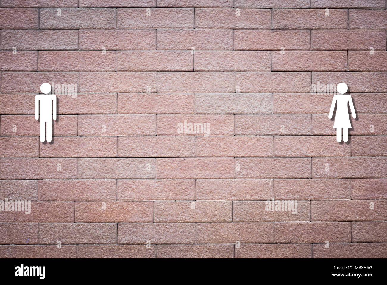 White symbol of man and woman on red brick wall Stock Photo - Alamy