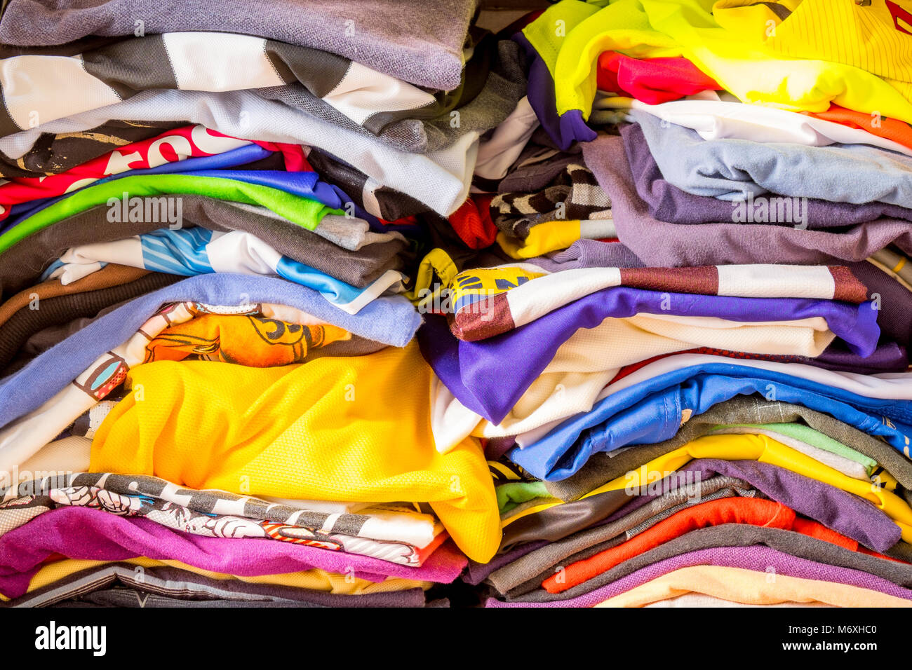 Messy folded colorful T-shirt stacking in the closet Stock Photo - Alamy