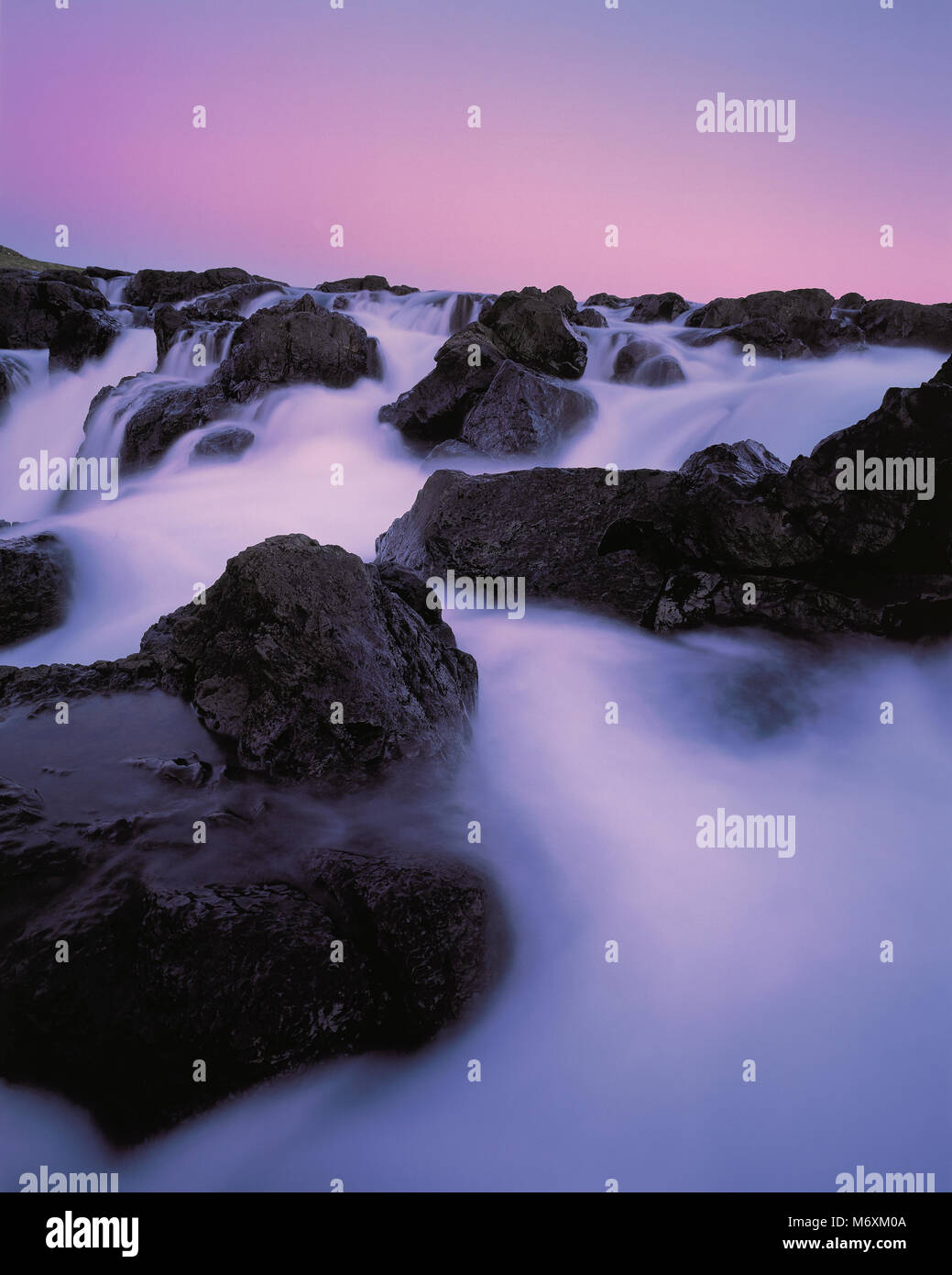 Sunset-Rocks and waterfalls, Western Iceland Stock Photo - Alamy