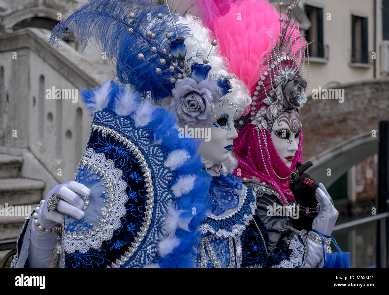 Two ladies holding fans, and wearing hand painted masks and ornate ...