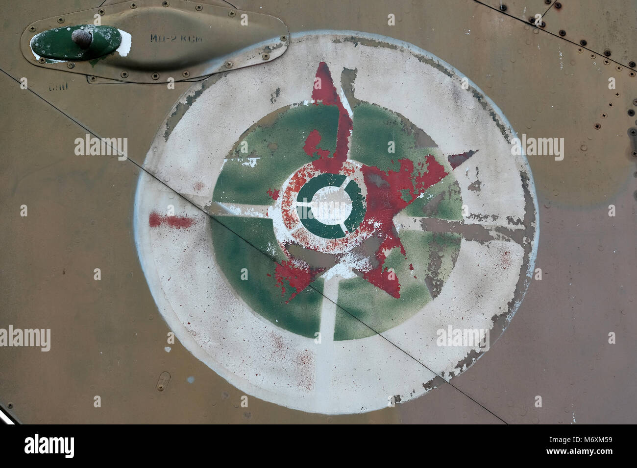 Peeled paint of a soviet military roundel on side of an old MIG combat ...