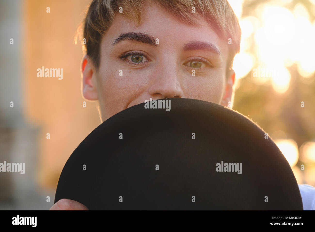 Woman face behind hat hi-res stock photography and images - Alamy
