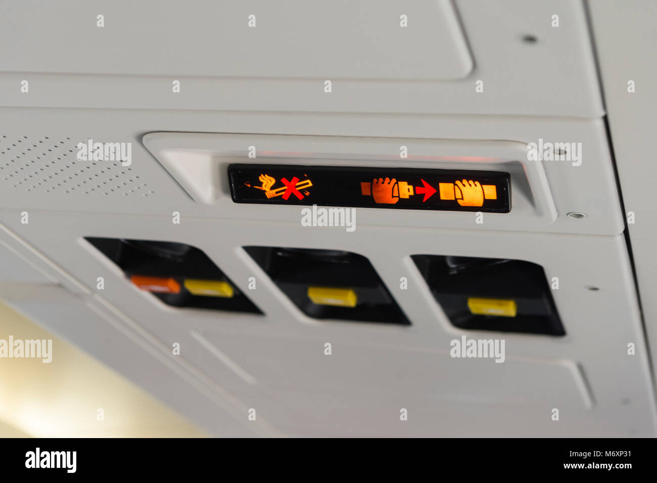 backlit sign of fasten seatbelt seat belt and no smoking on an airplane ...