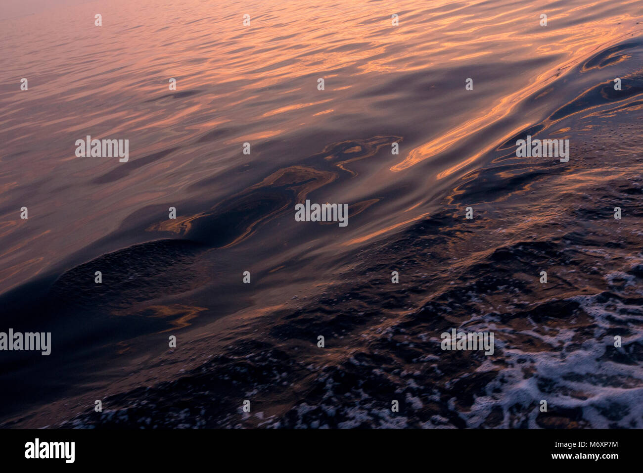 Ripples on the sea at sunset taken from a boat Stock Photo - Alamy