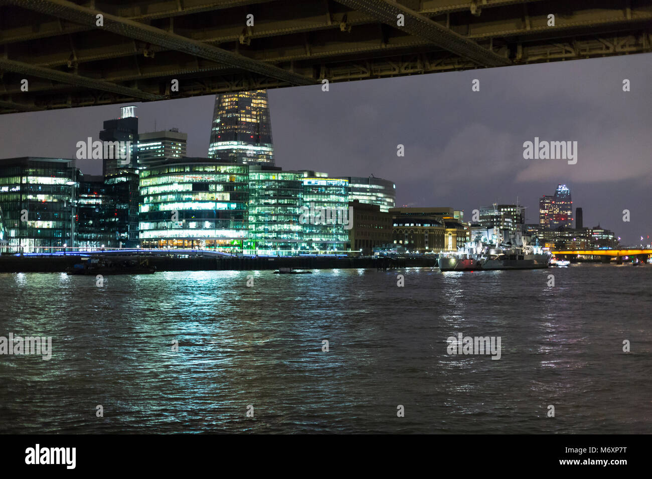 View from under London Bridge including The Shard and HMS Belfast ...