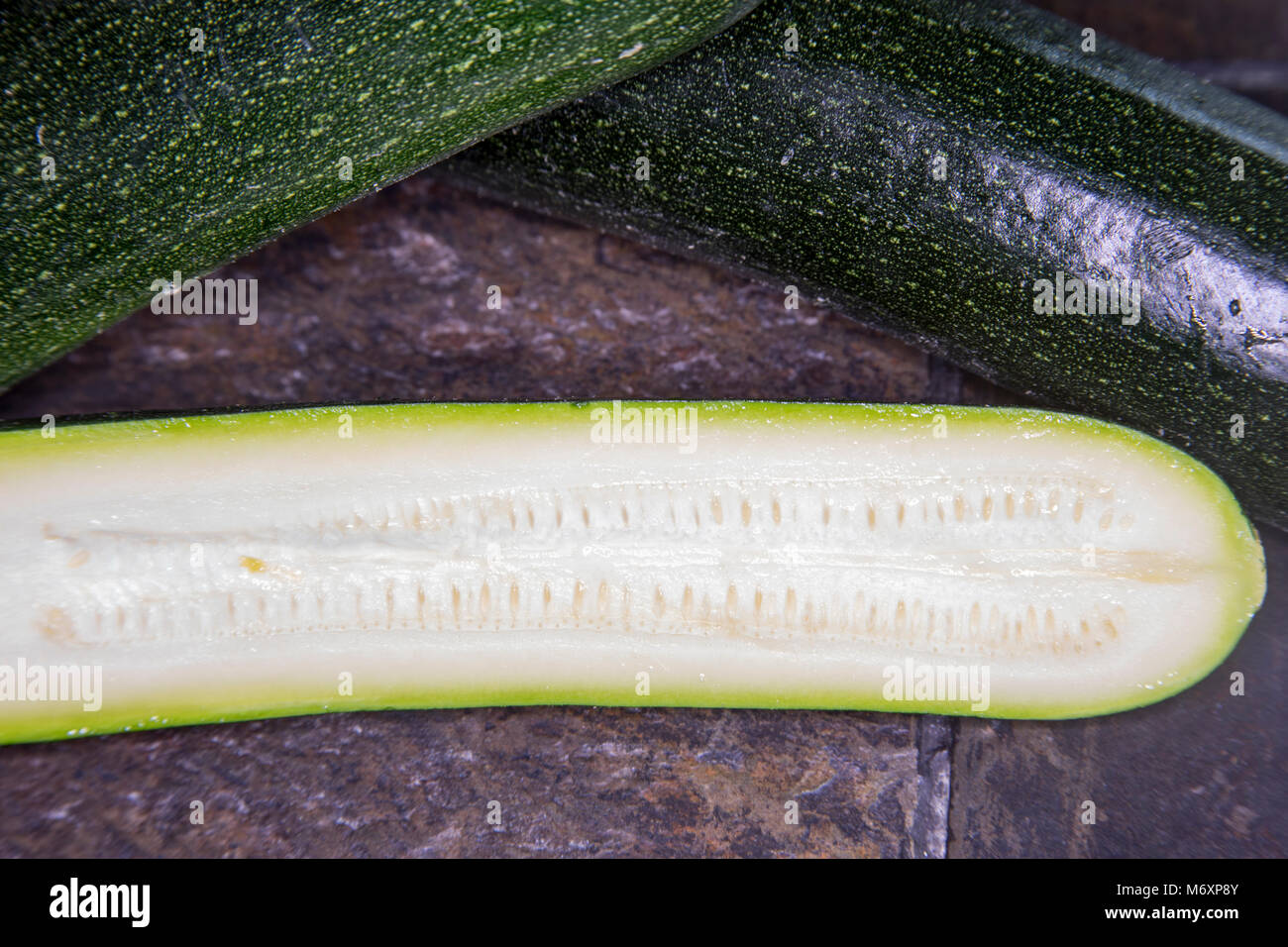 Close up of fresh whole natural organic green zucchini or courgette on ...