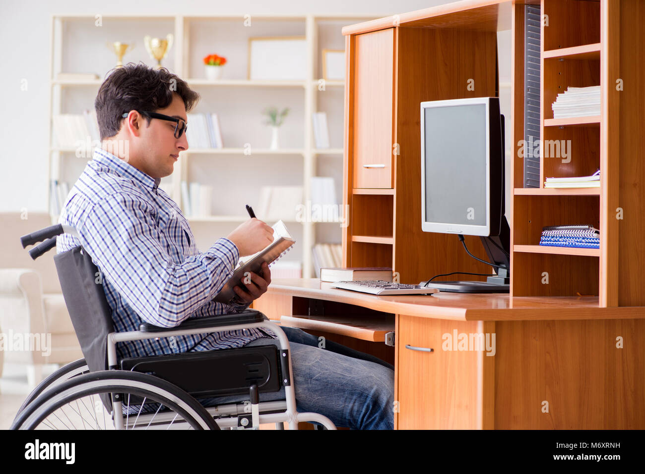 Disabled student studying at home on wheelchair Stock Photo - Alamy