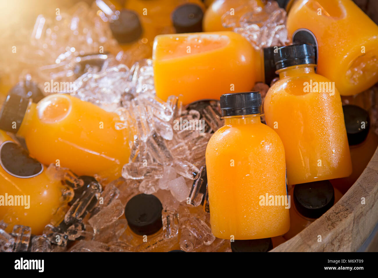 Orange juice bottles on the ice box Stock Photo - Alamy