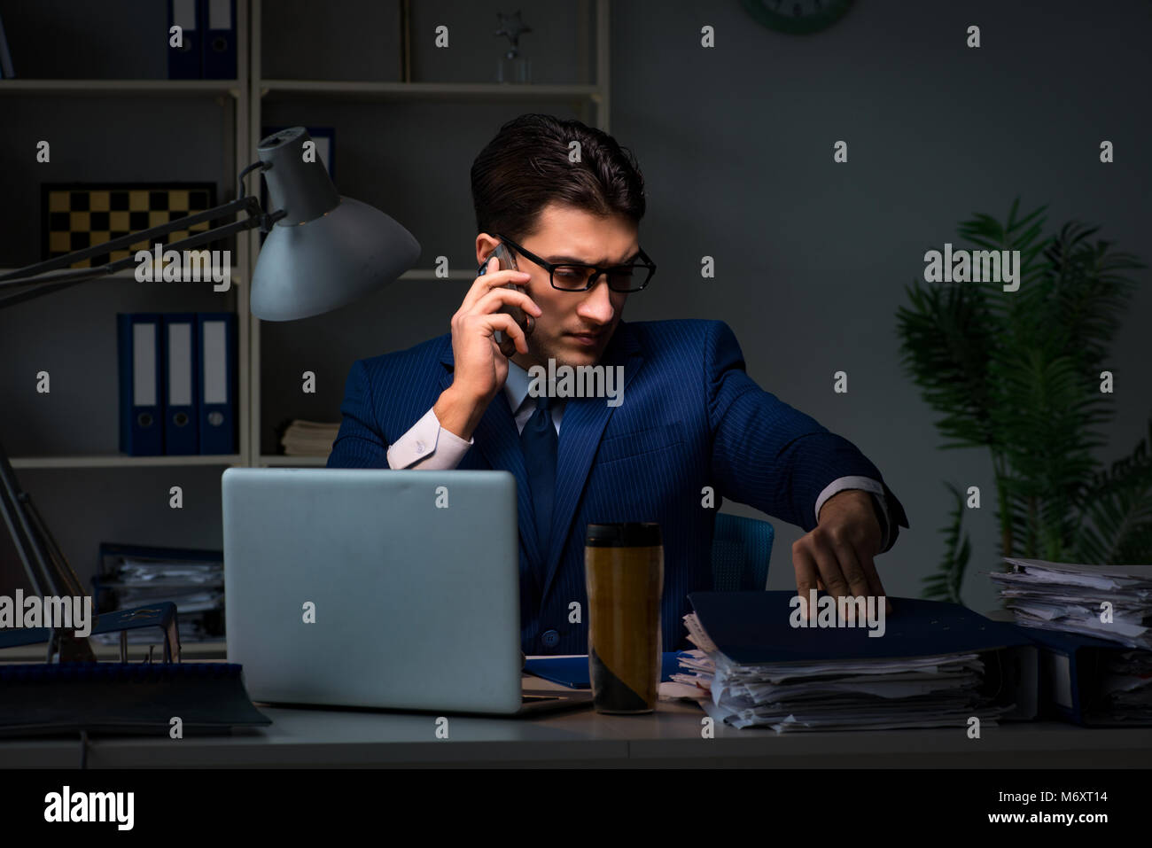 Employee working late to finish important deliverable task Stock Photo ...