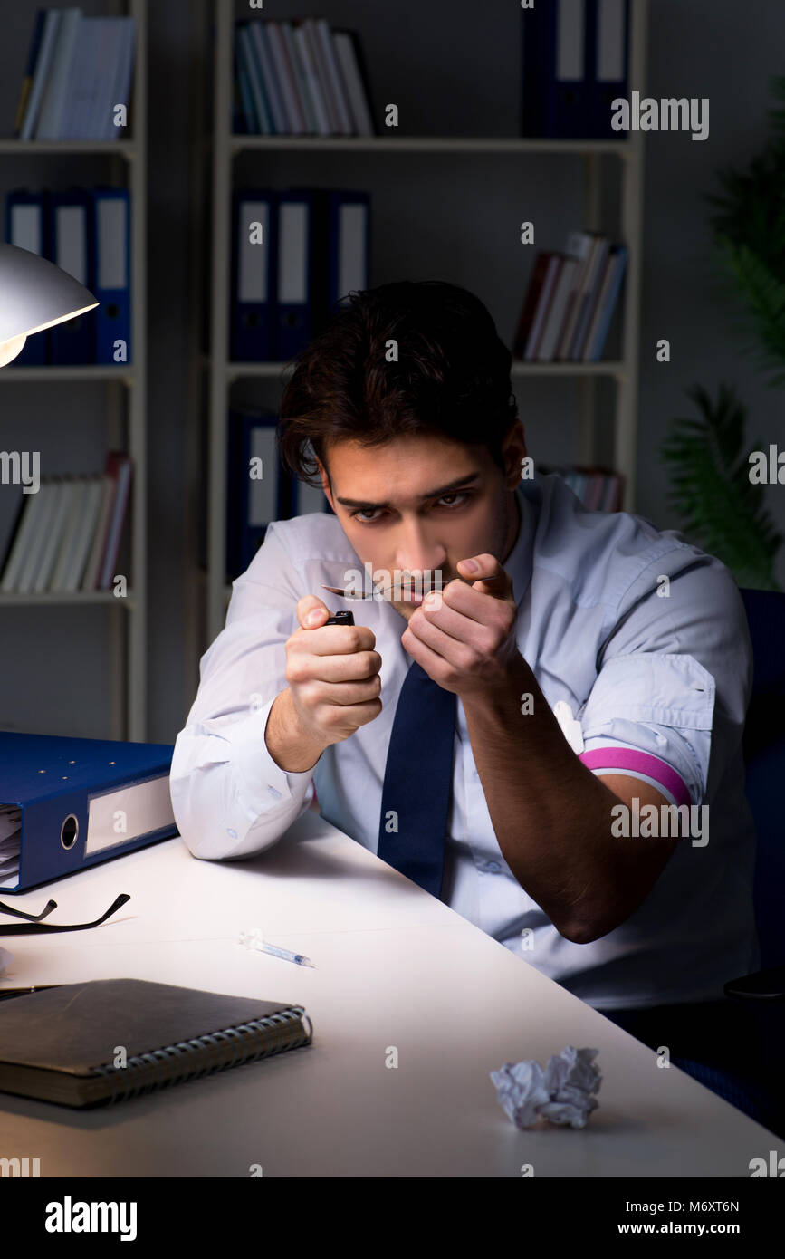 Employee relieving stress from overtime with drugs narcotics Stock ...