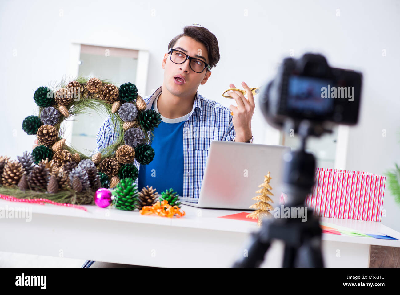 Young vlogger recording video doing christmas decoration Stock Photo ...