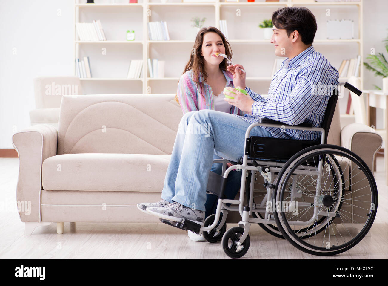 Young family taking care of each other Stock Photo - Alamy