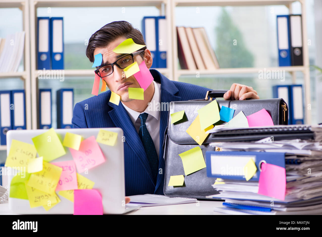 Businessman with reminder notes in multitasking concept Stock Photo - Alamy