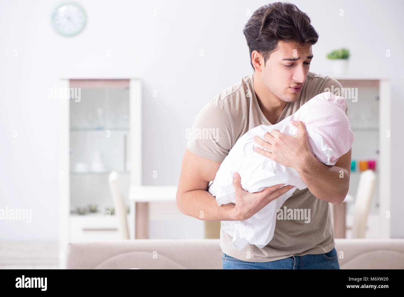 Young father dad frustrated at crying baby Stock Photo - Alamy