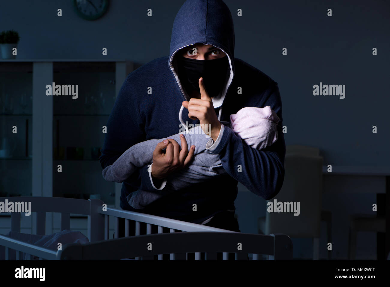 Criminal stealing baby in human child traficking concept Stock Photo ...