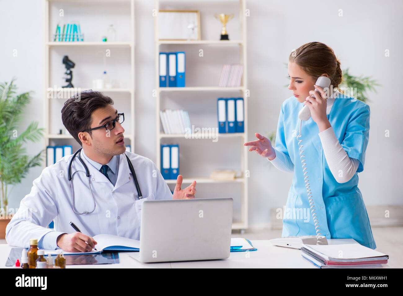 Male and female doctor having discussion in hospital Stock Photo - Alamy