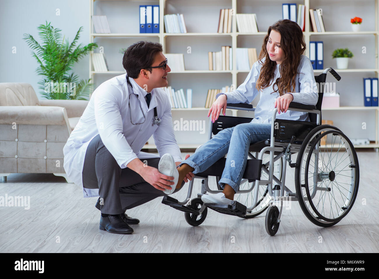 Disabled patient on wheelchair visiting doctor for regular check up ...