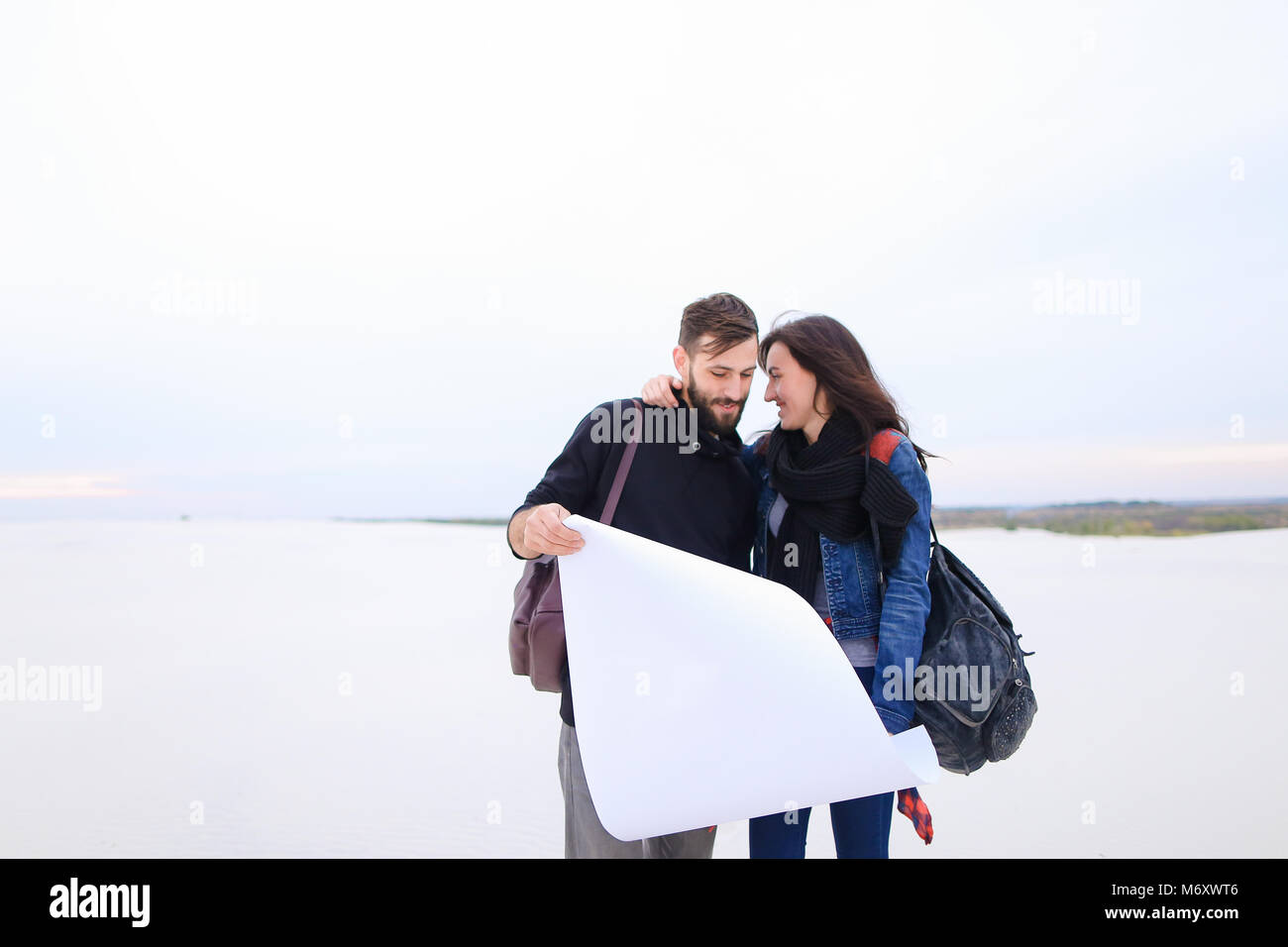 Presenters of travel program married couple viewing map Stock Photo - Alamy