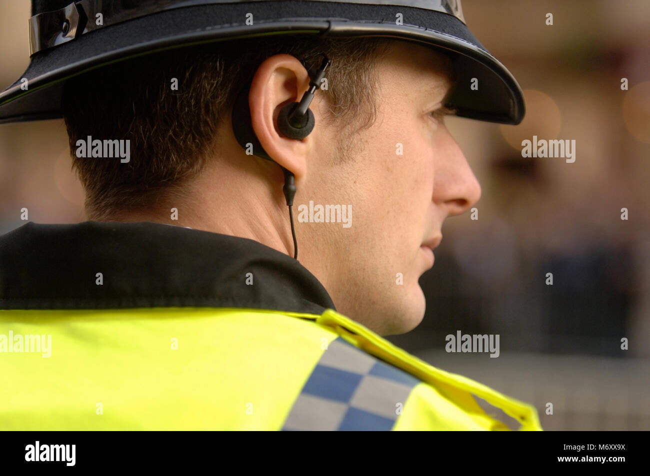 Police Officer with earpiece during the Wedding of Elton John to David ...